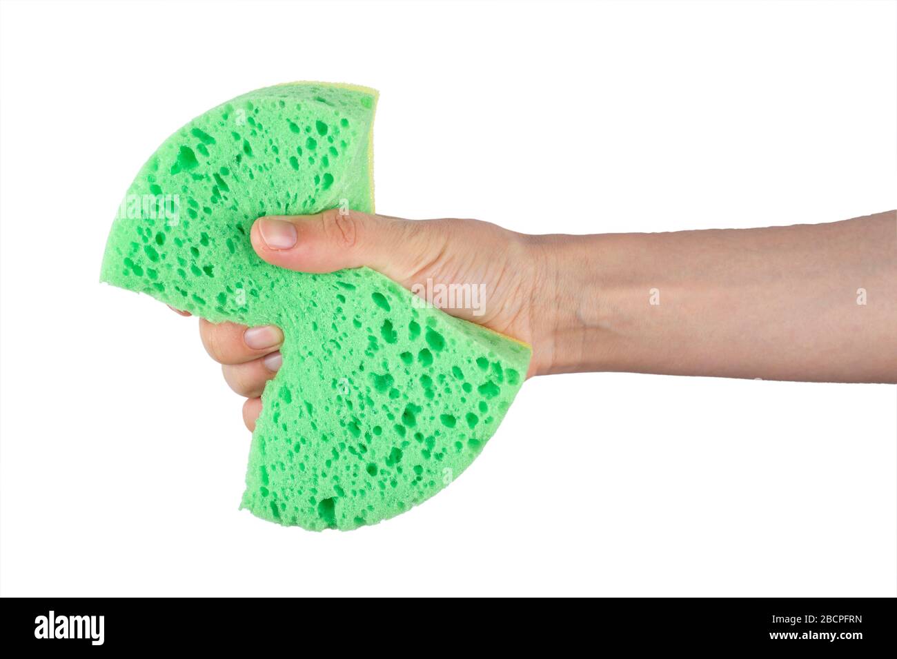 In hand a sponge for cleaning on a white background, workhouse concept ...