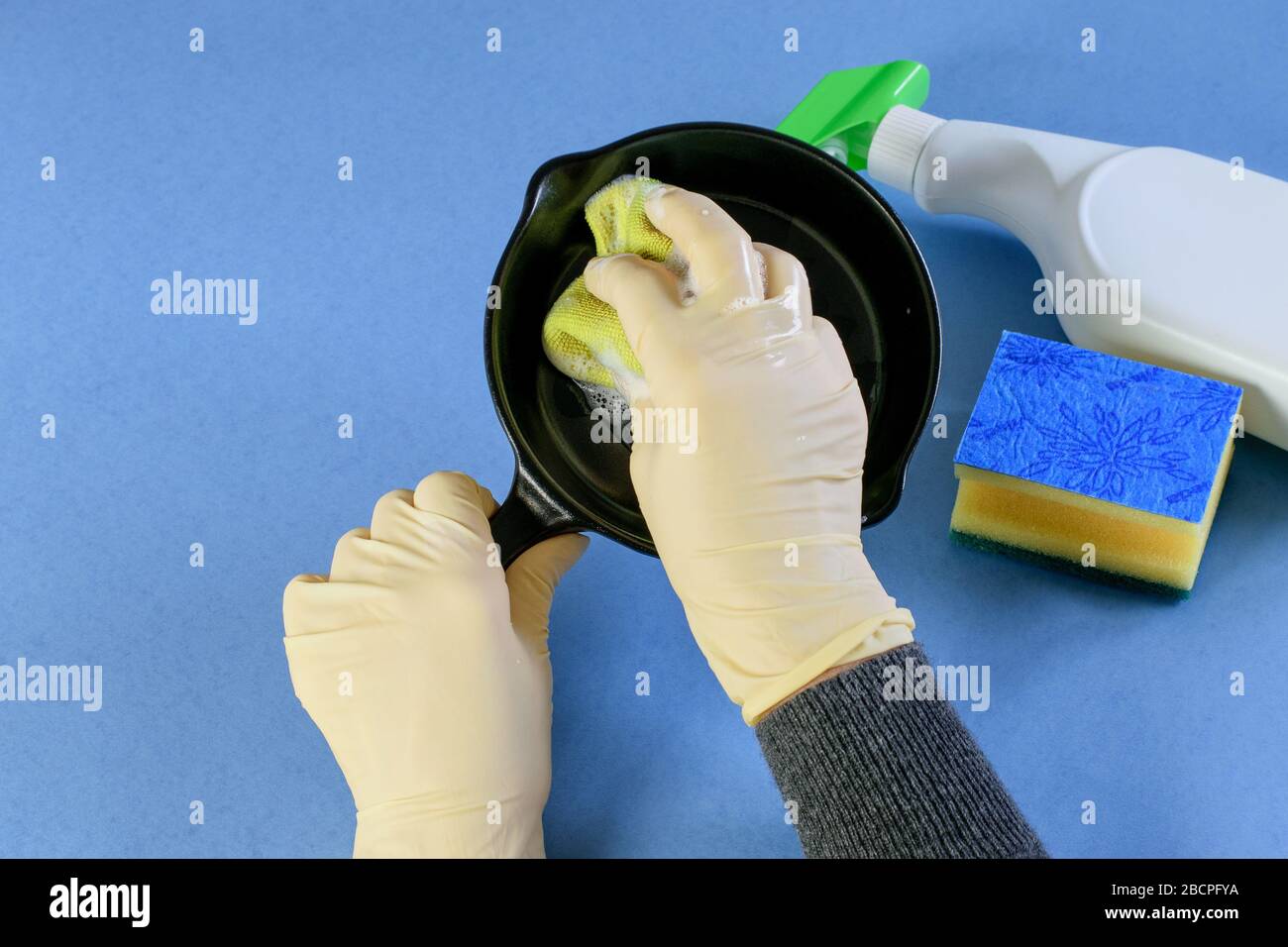 Female hands handing and washing kitchen pan with cleaning products on ...