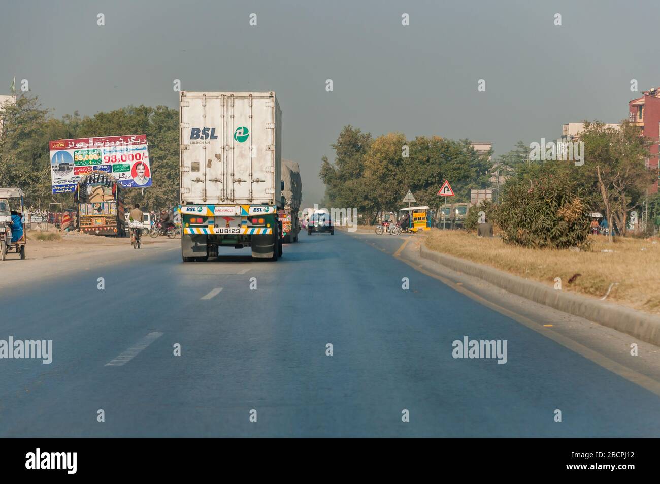 Mangla Road unidentified People ride motorcycle and car on the local ...