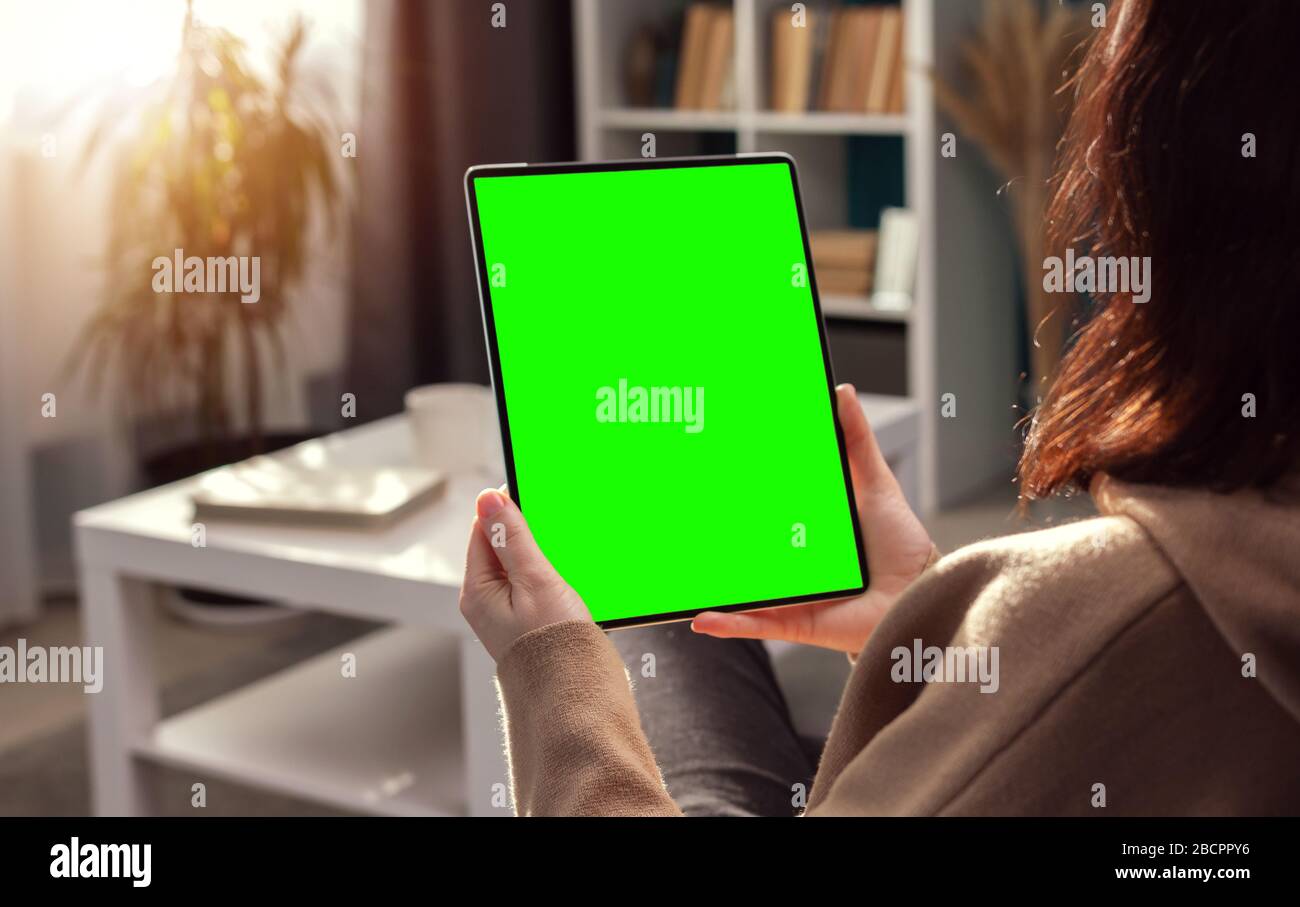 Woman looking at vertical tablet Stock Photo - Alamy