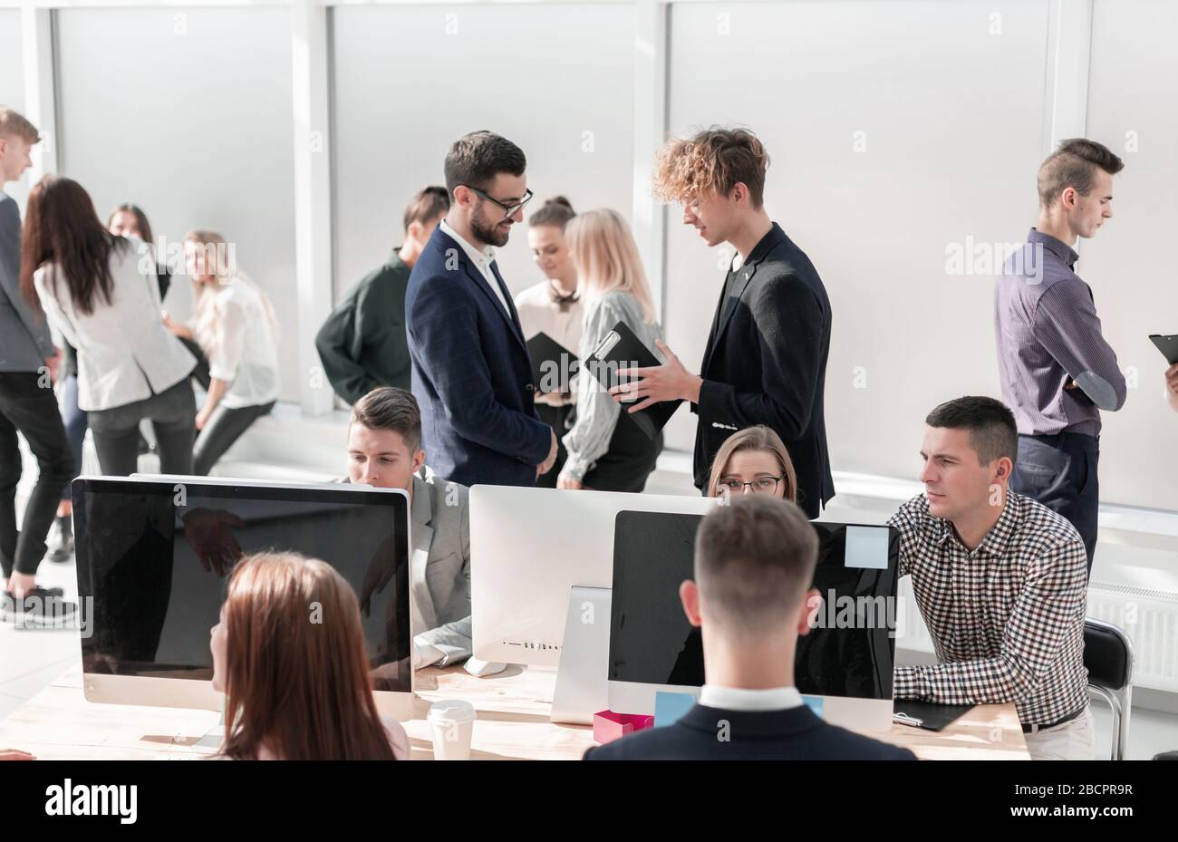 employees discussing work issues in the office Stock Photo - Alamy