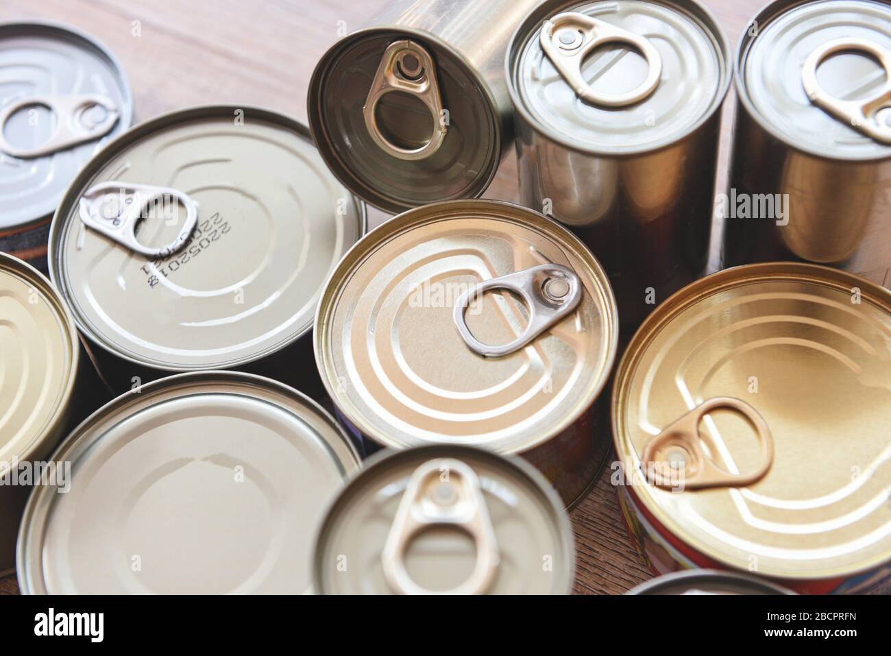 Various canned food in metal cans on wooden background , top view ...