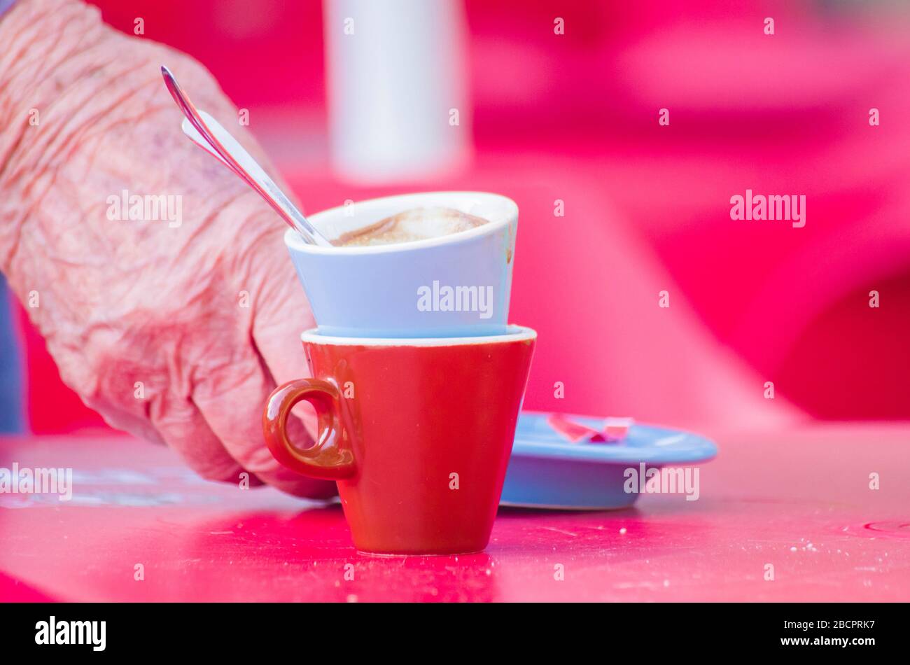 the old barista takes the used coffee cups and brings them to wash ...