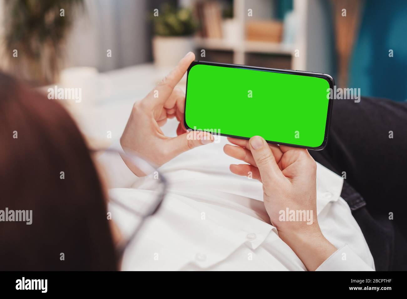 Human hands holding horizontal smartphone Stock Photo - Alamy