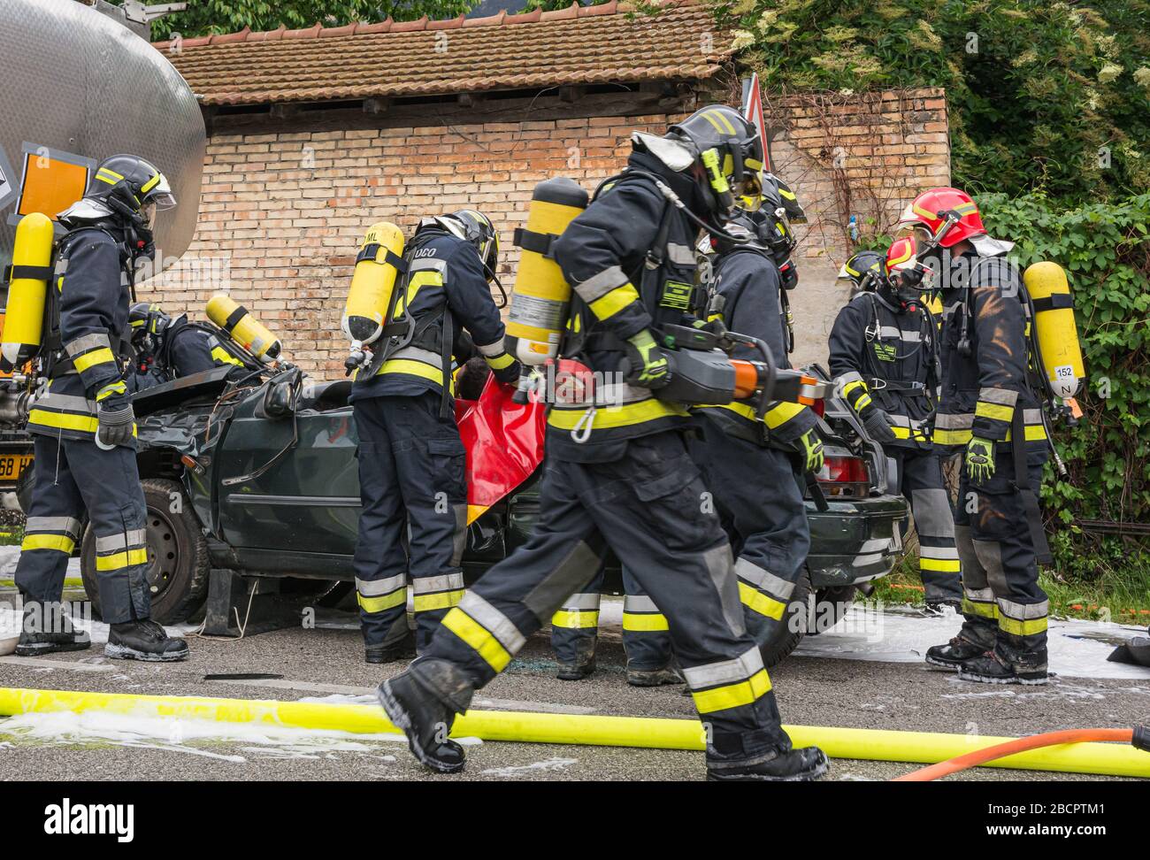 firefighters crewss rescue trapped driver during a road accident ...