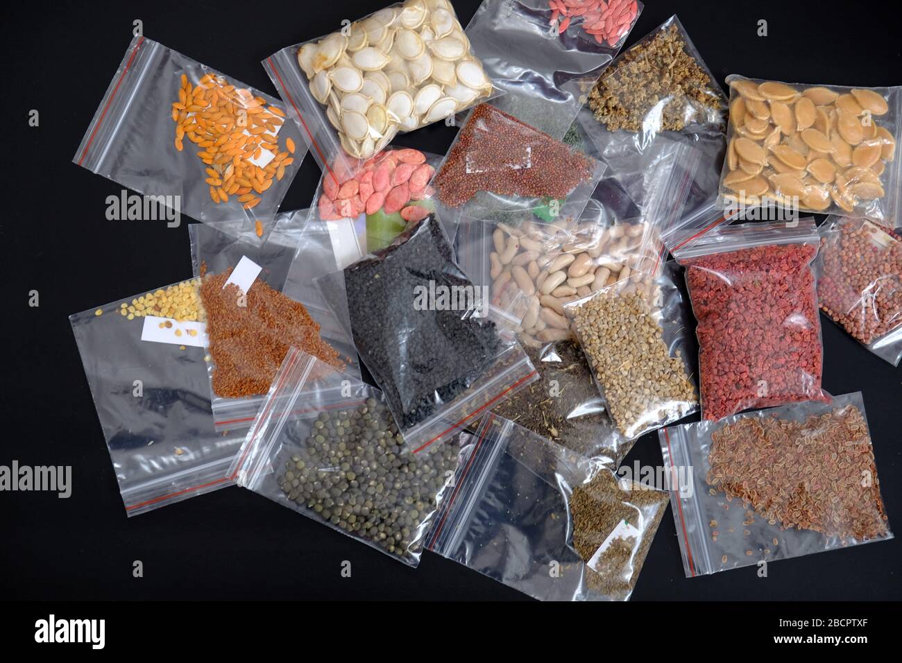 organic seeds packed in a wide variety on black ground Stock Photo - Alamy