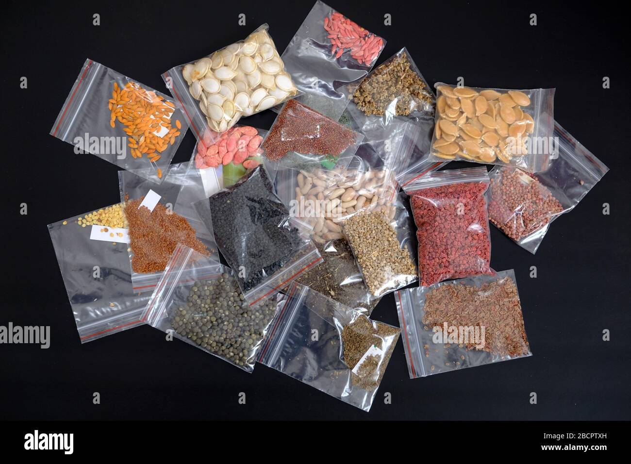 organic seeds packed in a wide variety on black ground Stock Photo - Alamy