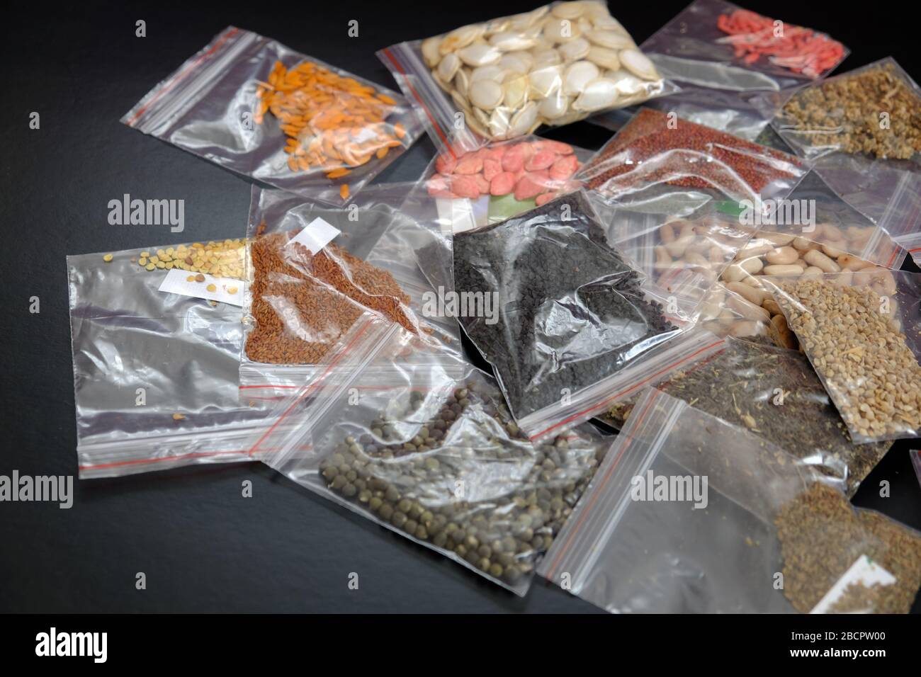 organic seeds packed in a wide variety on black ground Stock Photo - Alamy