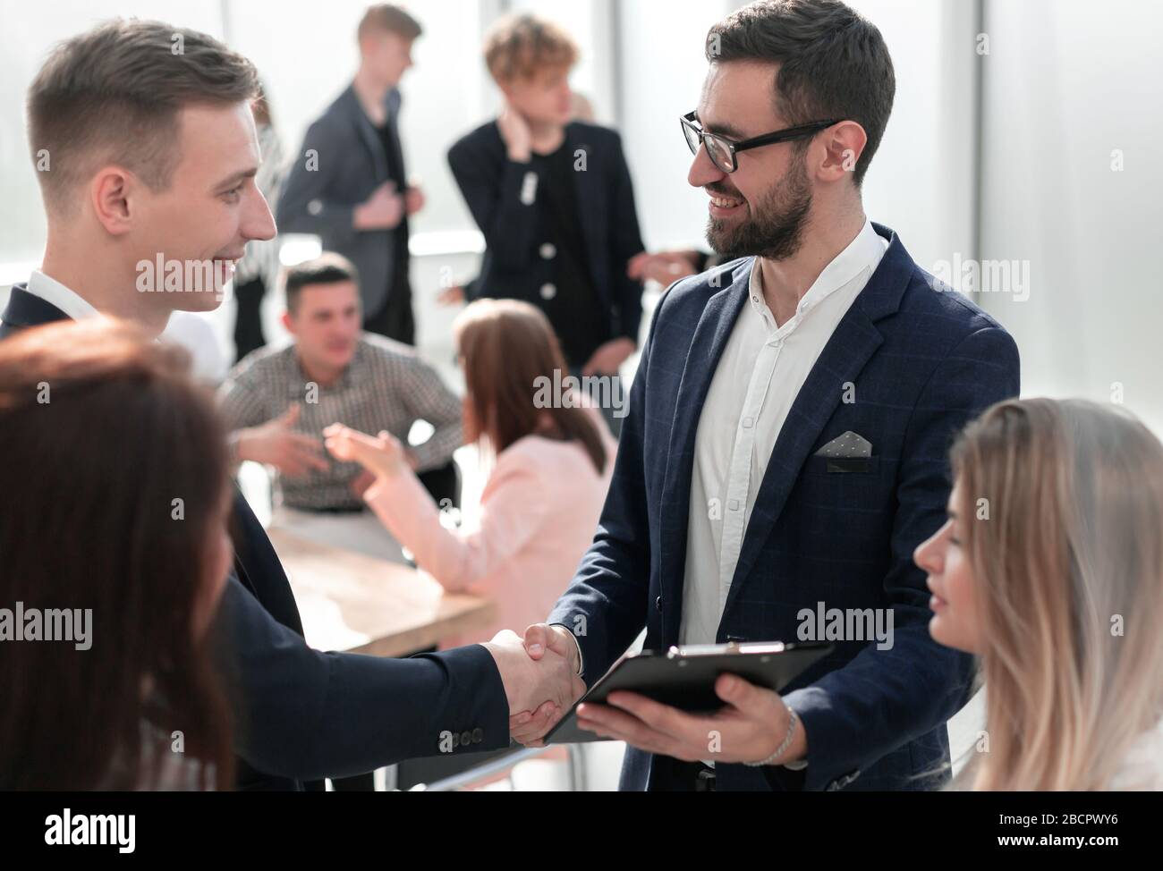 business people greet each other in the office Stock Photo - Alamy
