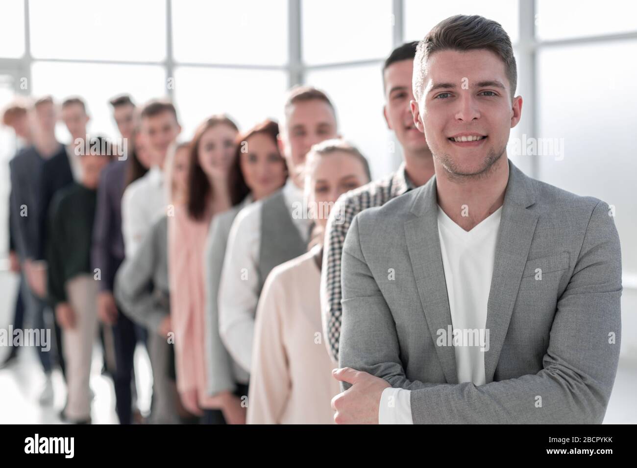 confident guy standing in line of diverse young people Stock Photo - Alamy