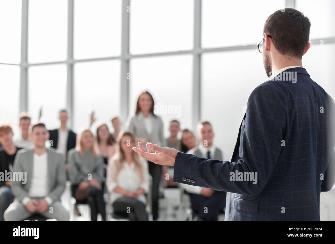 close up. speaker standing in front of the audience in the conference ...