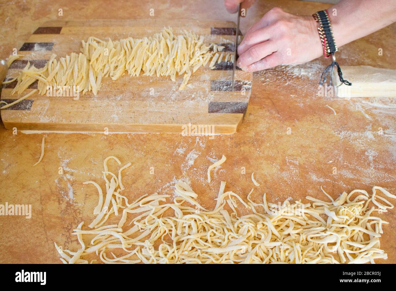Pasta home making closeup in kitchen interior. The cooking process, raw ...