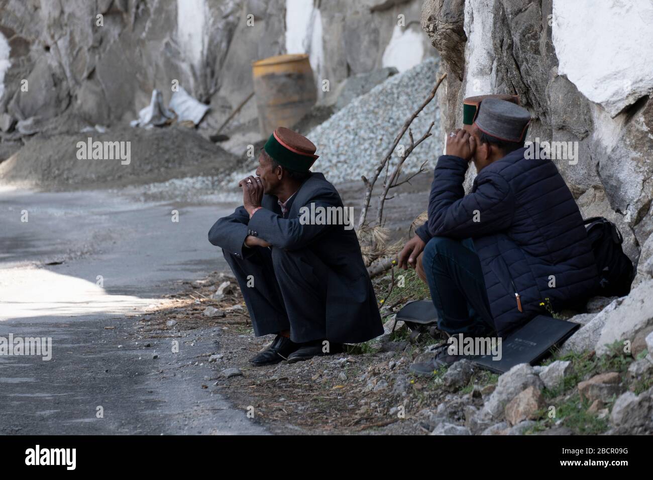 Passengers enjoy a smoke break while awaiting the next bus due to the ...