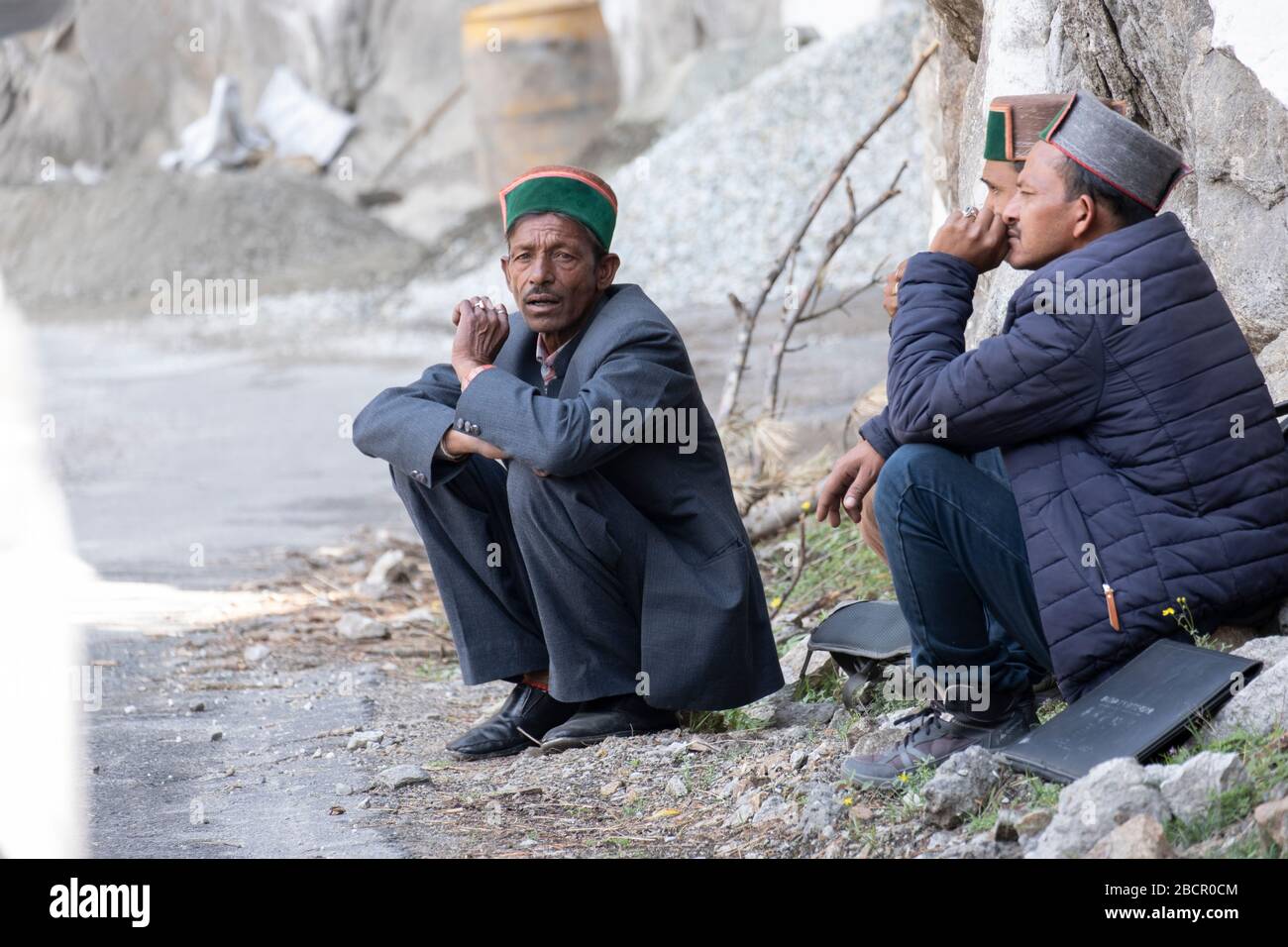 Passengers enjoy a smoke break while awaiting the next bus due to the ...