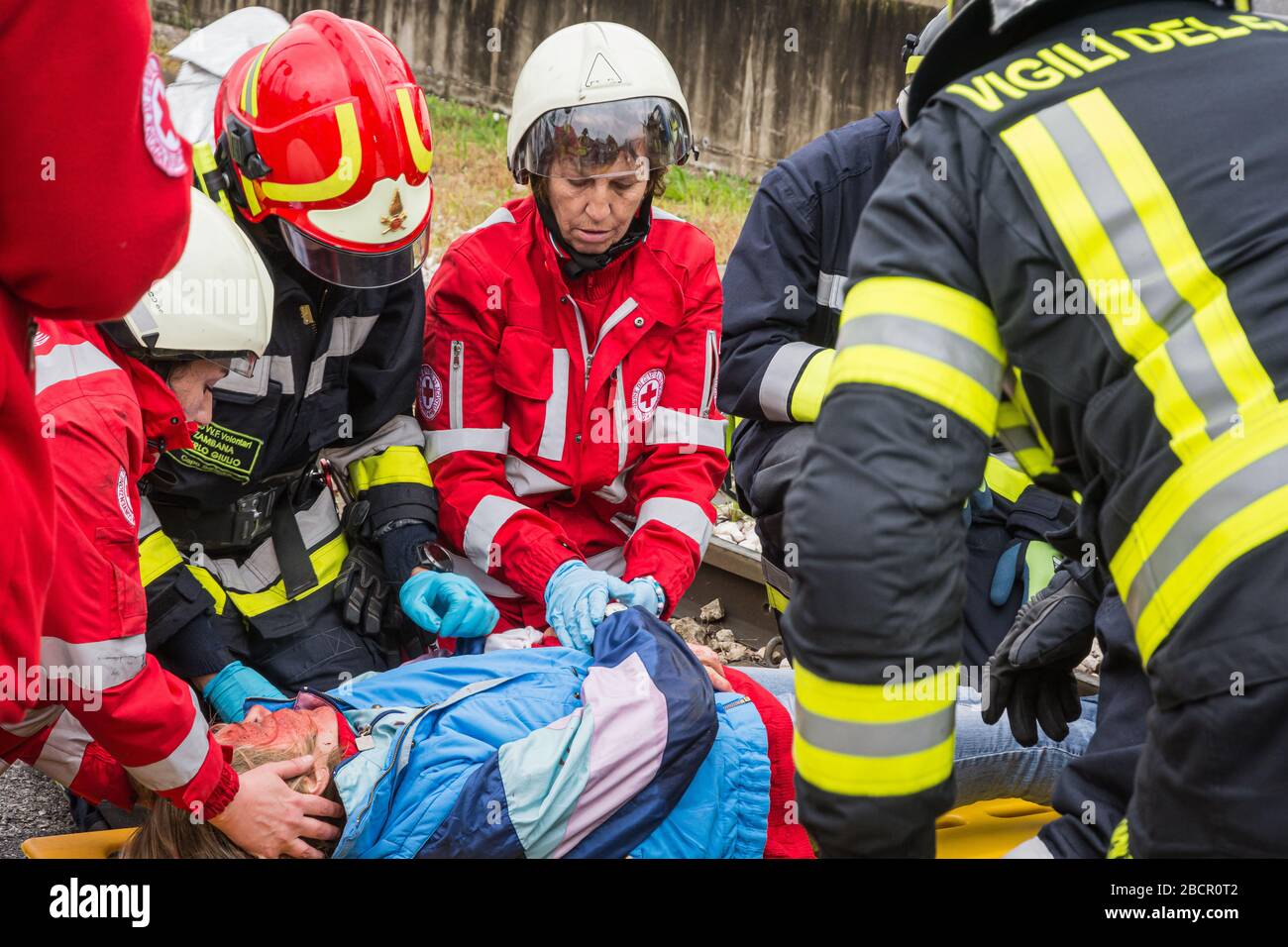 Emergency service personnel free an injured driver at the scene of a ...