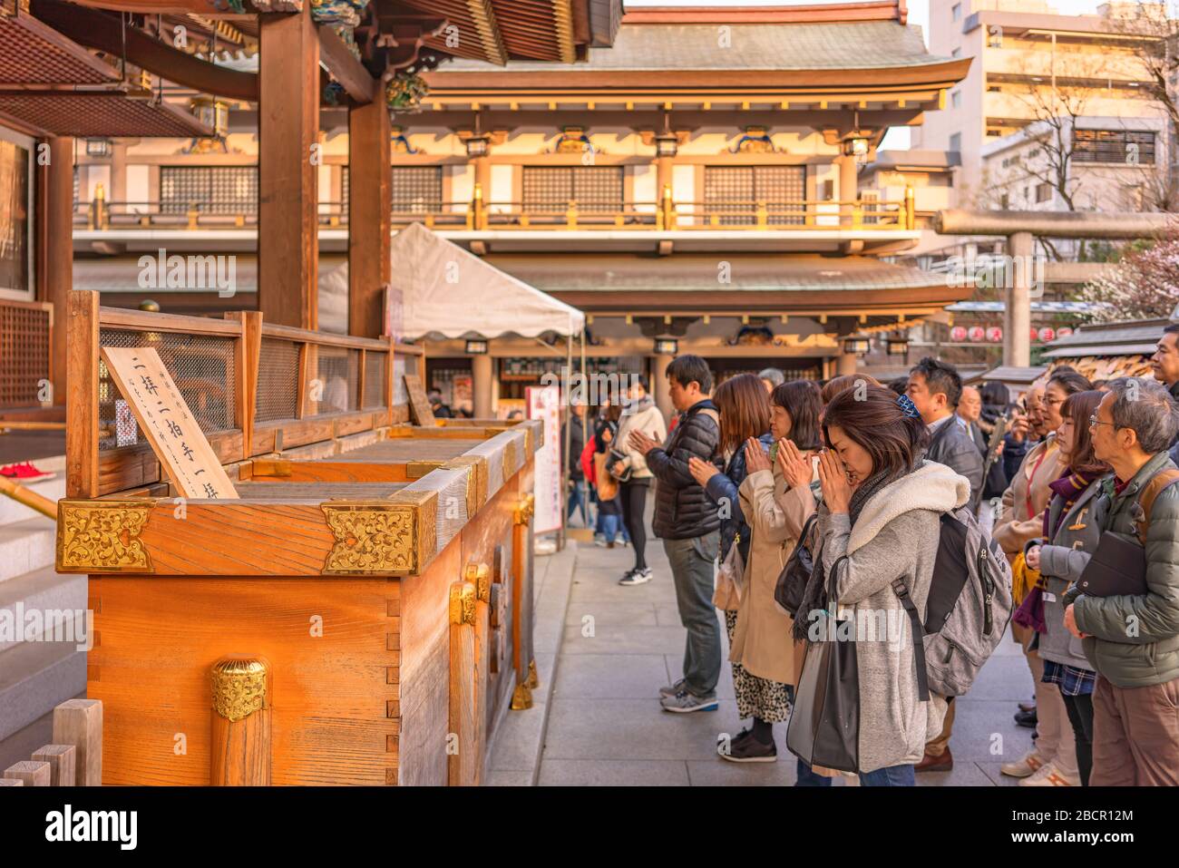 tokyo, japan - march 02 2020: Japanese queuing and praying in the ...