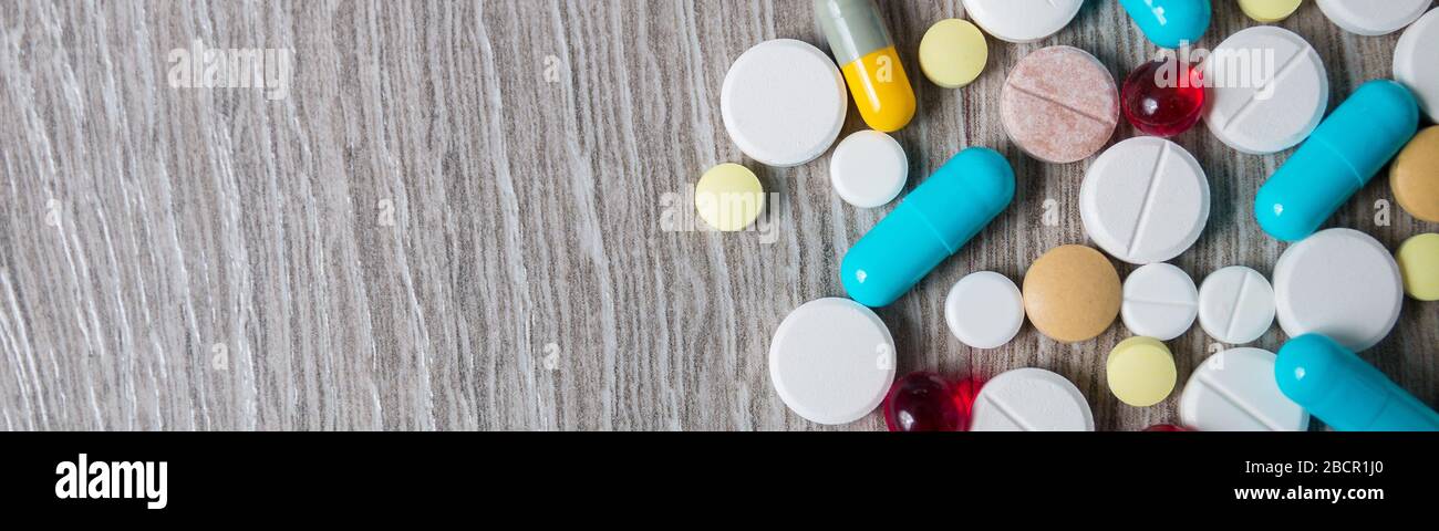 Banner of A lot of colorful medication and pills from above on grey ...