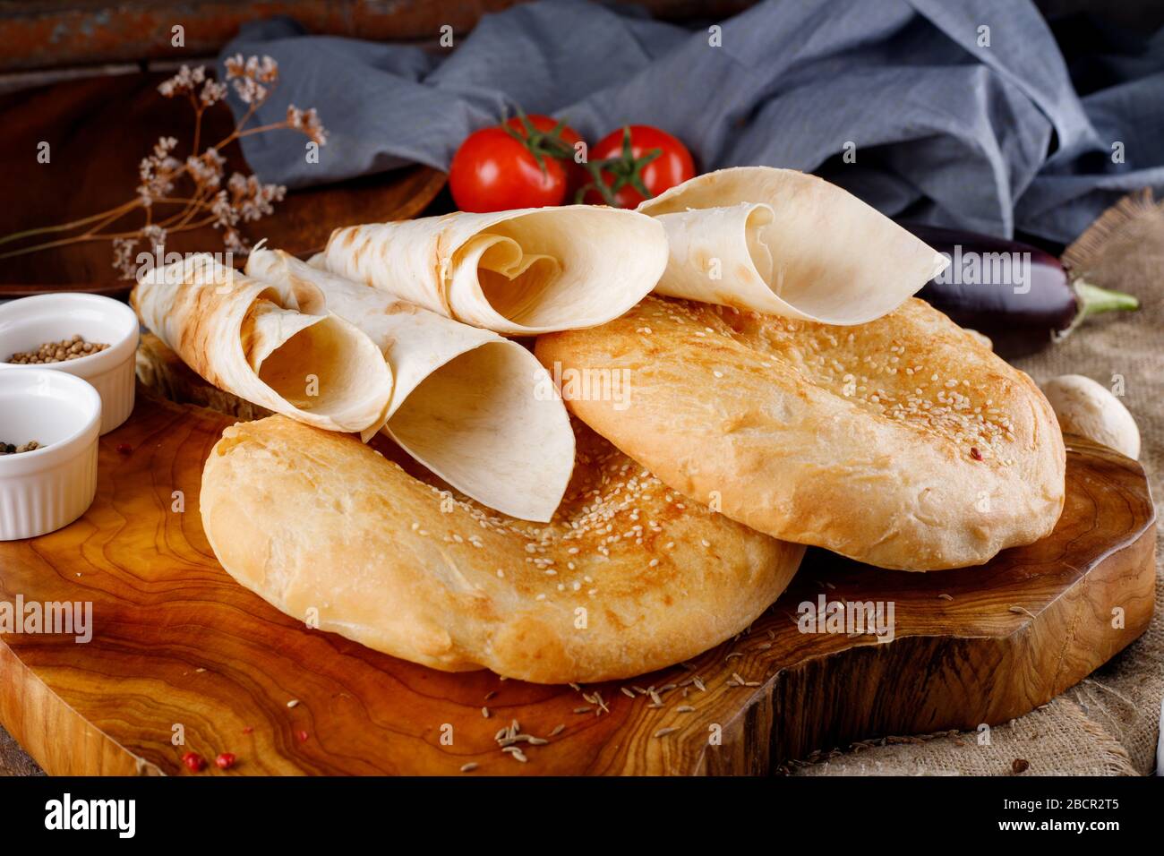 Different types of bread on a wooden Board on a table background Stock ...