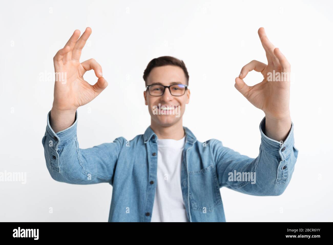 Happy guy showing ok sign his hands Stock Photo - Alamy