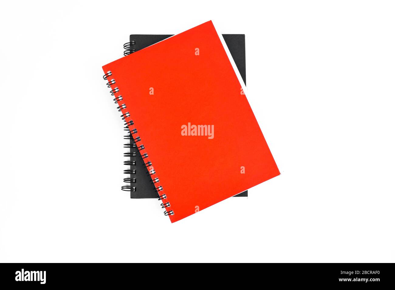 Couple of paper note diary of red and black color placed on top of each ...