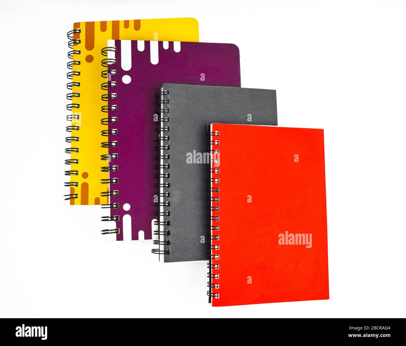 Four paper note diary of red black purple and yellow color placed on ...