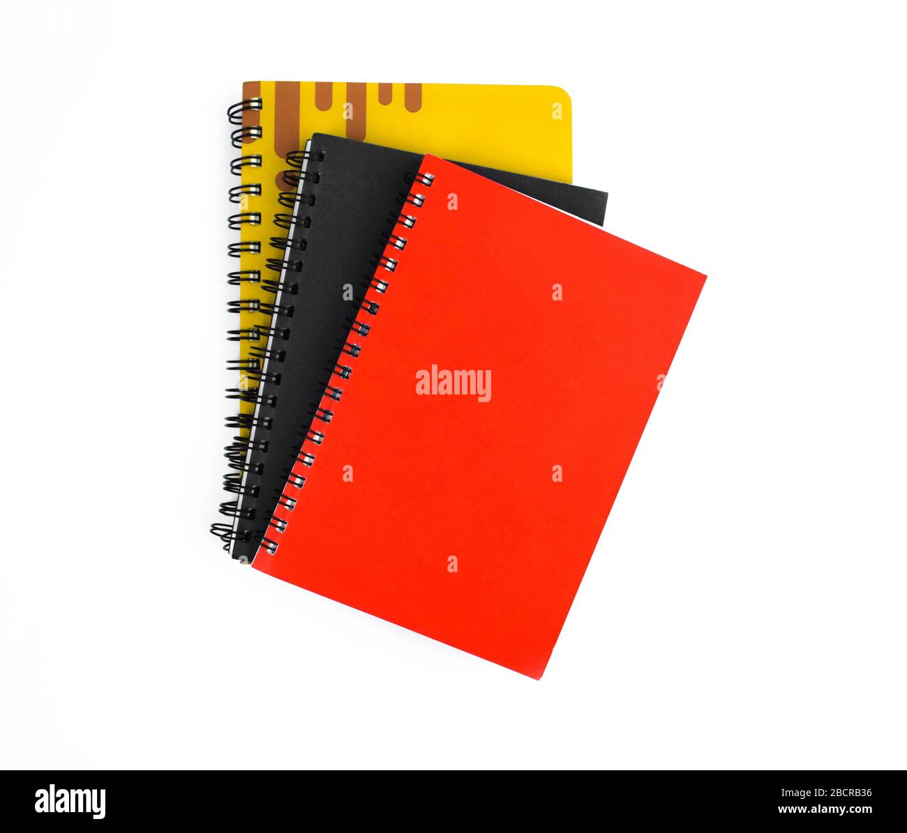 Three paper note diary of red black and yellow color placed on top of ...