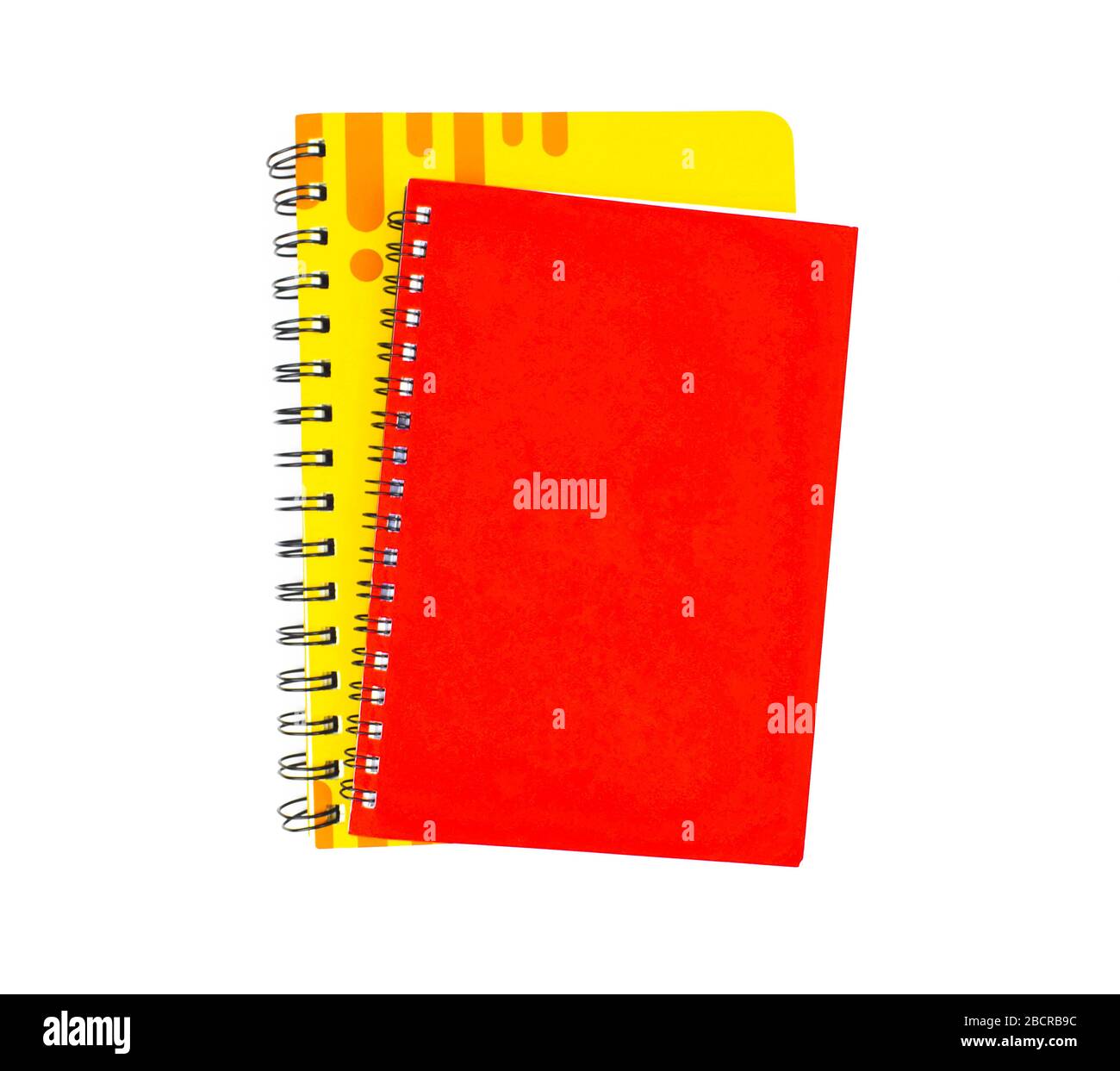 Two paper note diary of red and yellow color placed on top of each ...