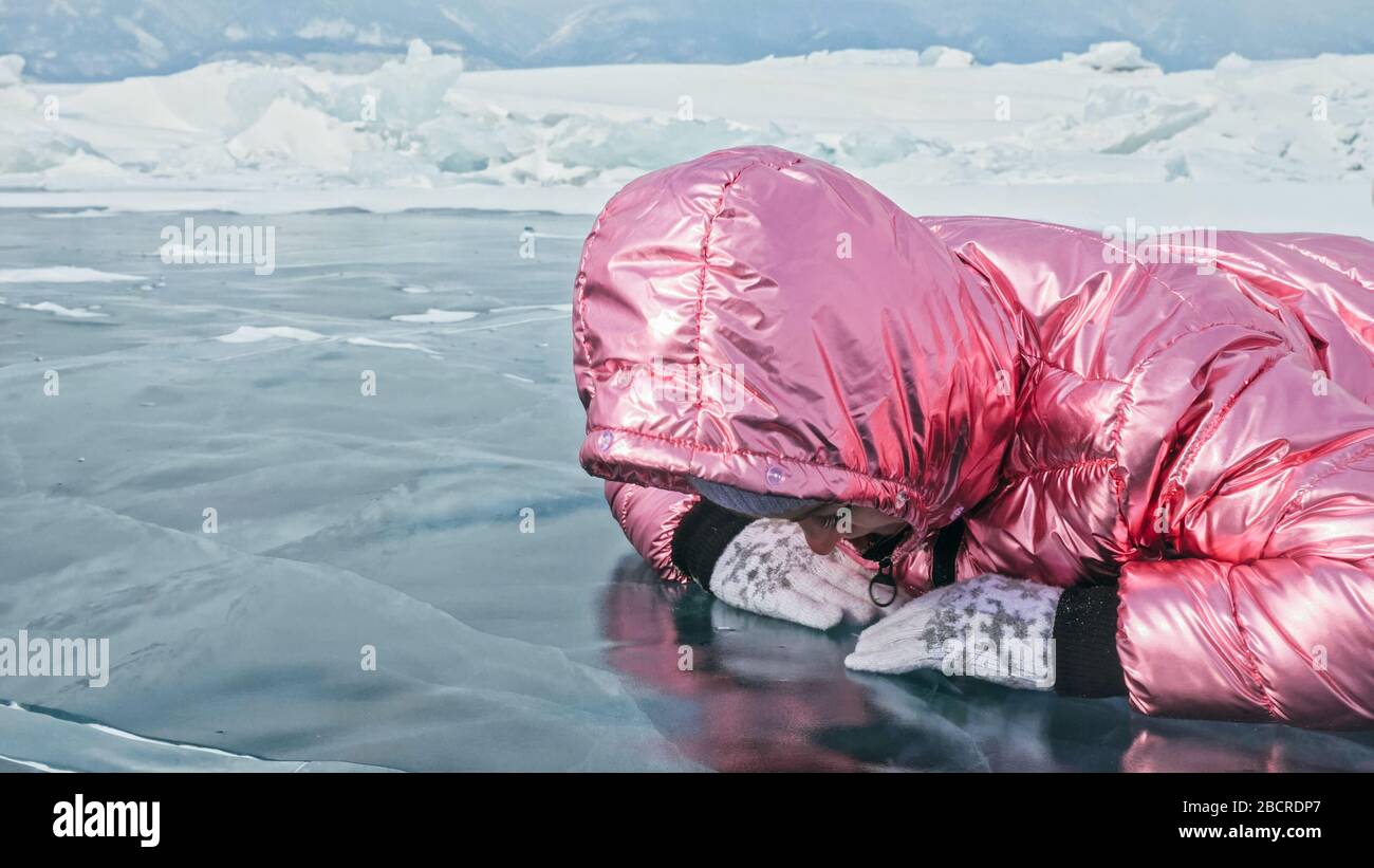 Girl walking on cracked ice of a frozen lake Baikal. Woman trave Stock ...