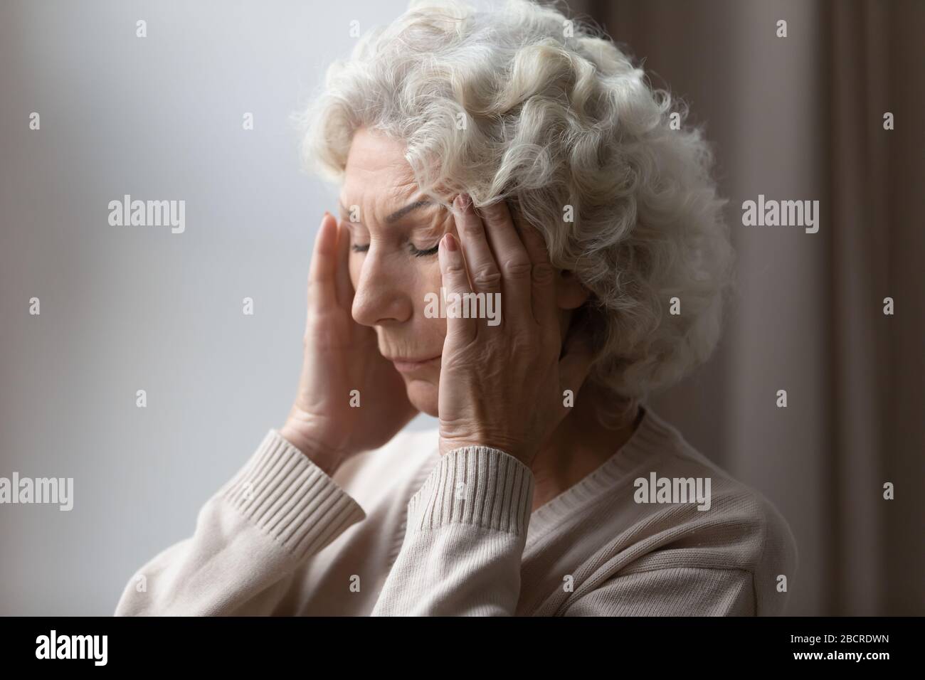 Unhappy elderly senior woman suffering from strong headache Stock Photo ...