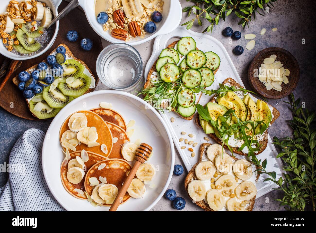 Healthy varied vegetarian breakfast table. Oatmeal with fruits, chia ...