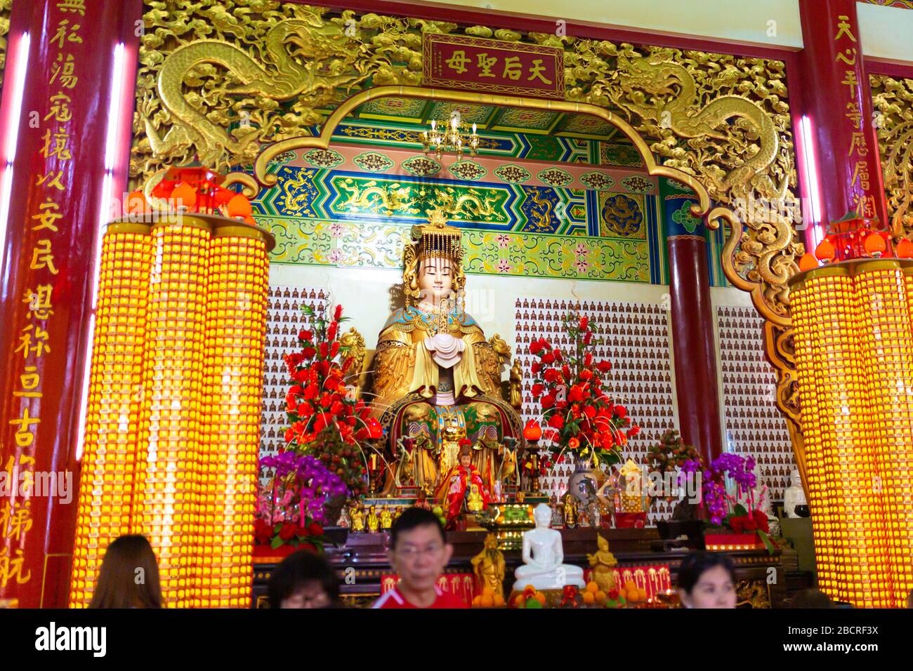 Deity statue in a Chinese temple with offerings Stock Photo - Alamy