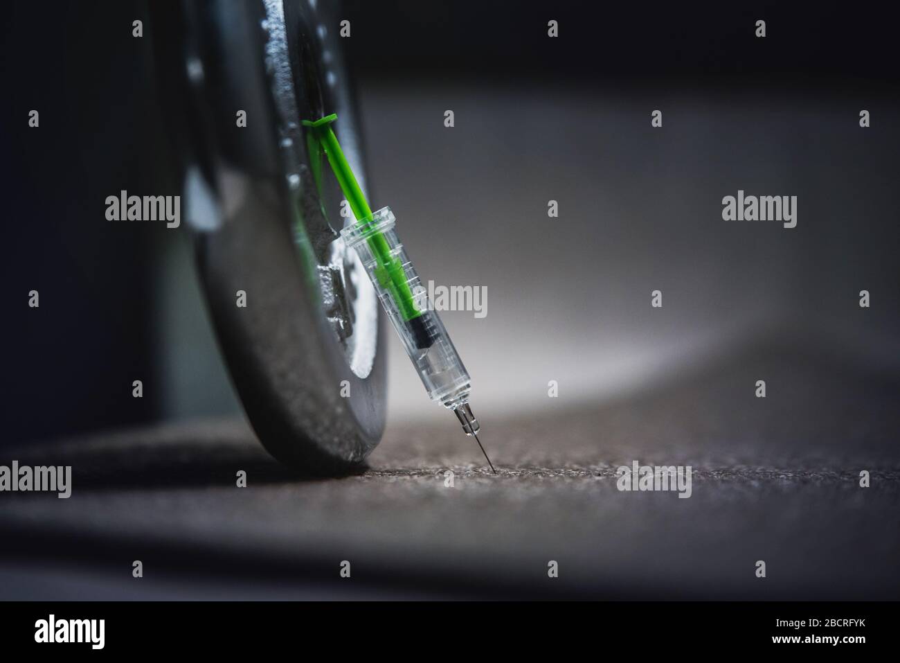 sport stimulants. metal barbells with syringe Stock Photo - Alamy