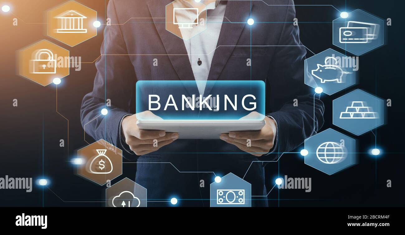 Online banking. Businessman holding tablet computer on dark background ...