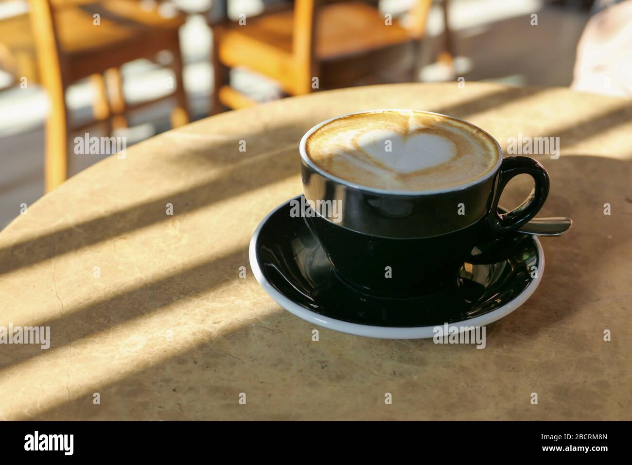 late coffee on cafe table with cafe background Stock Photo - Alamy