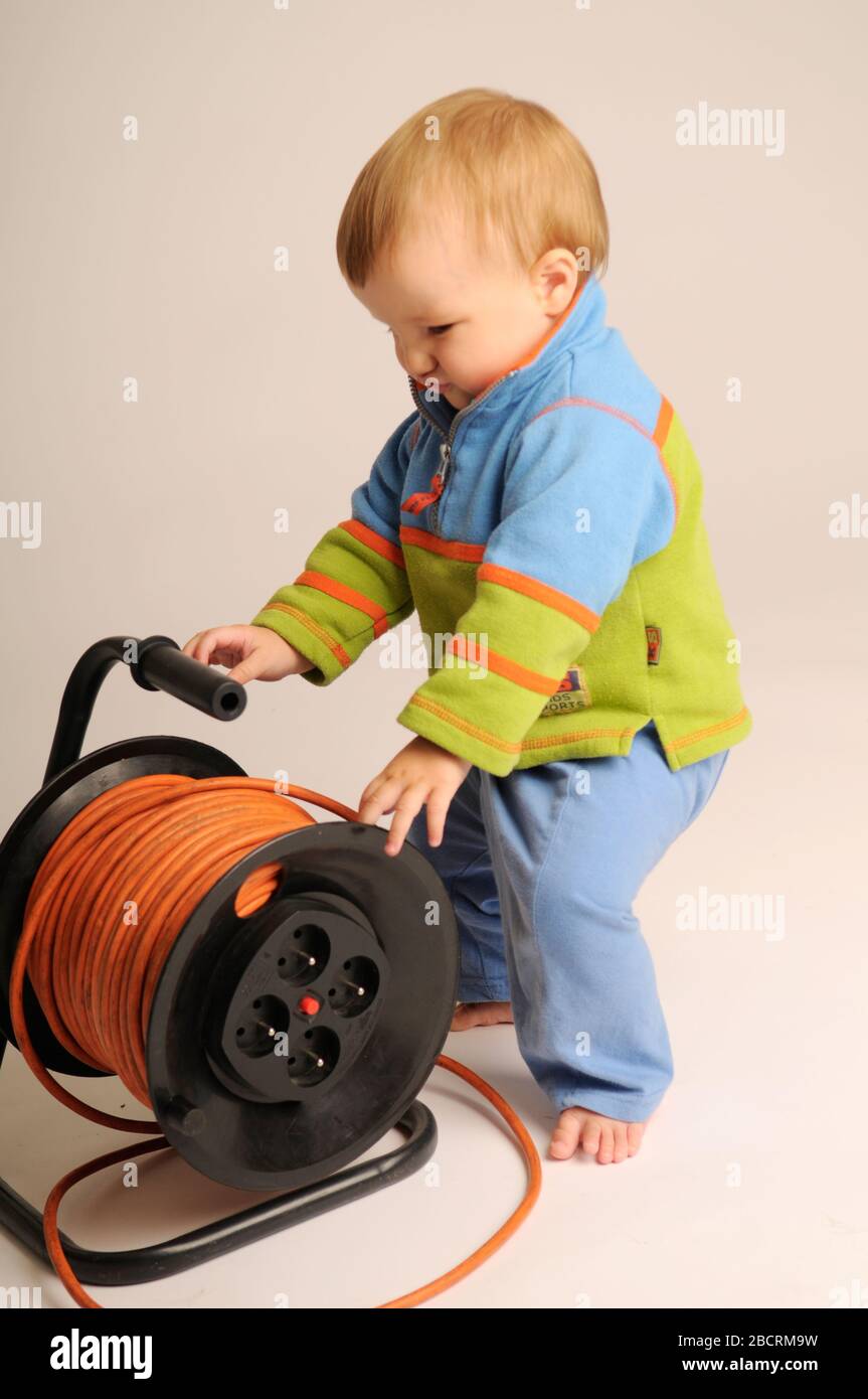 The baby with electric thing on white background Stock Photo - Alamy