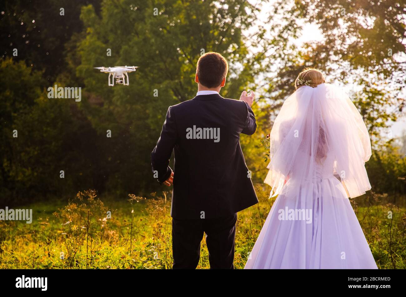 Wedding couple pose for drone photo in autumn nature Stock Photo - Alamy