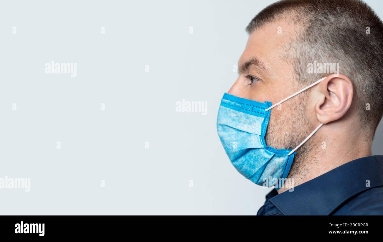 Man Wearing Medical Mask Posing Over White Background, Side View Stock ...