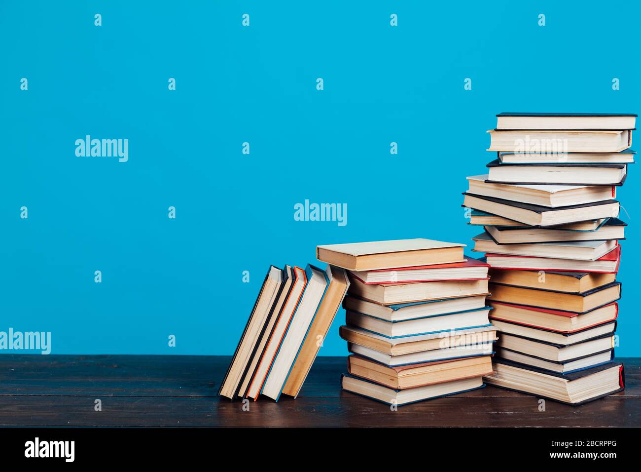 many stacks of educational books for learning preparation for college ...
