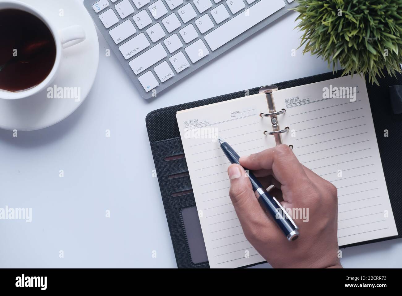 top view of man writing on notepad Stock Photo - Alamy