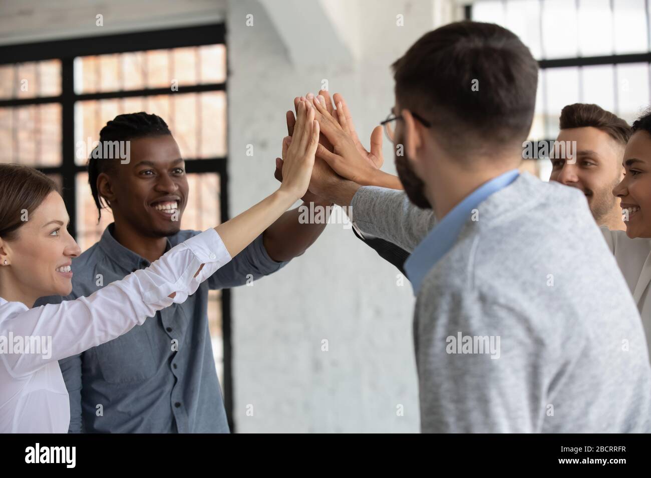 Concept of excited successful multiracial business people giving high ...