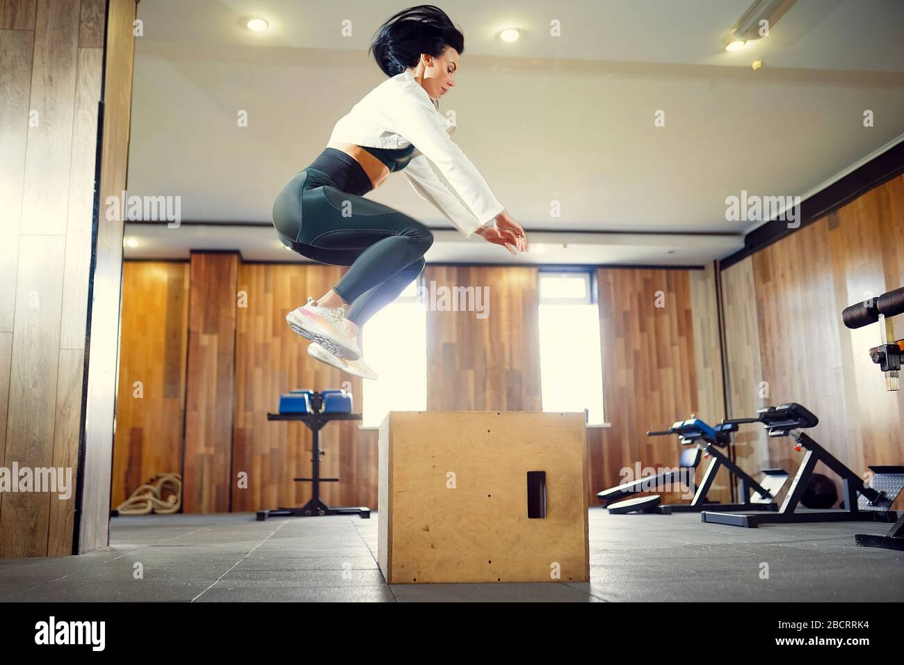 Shot of young woman working out with a box at the gym. Female athlete ...