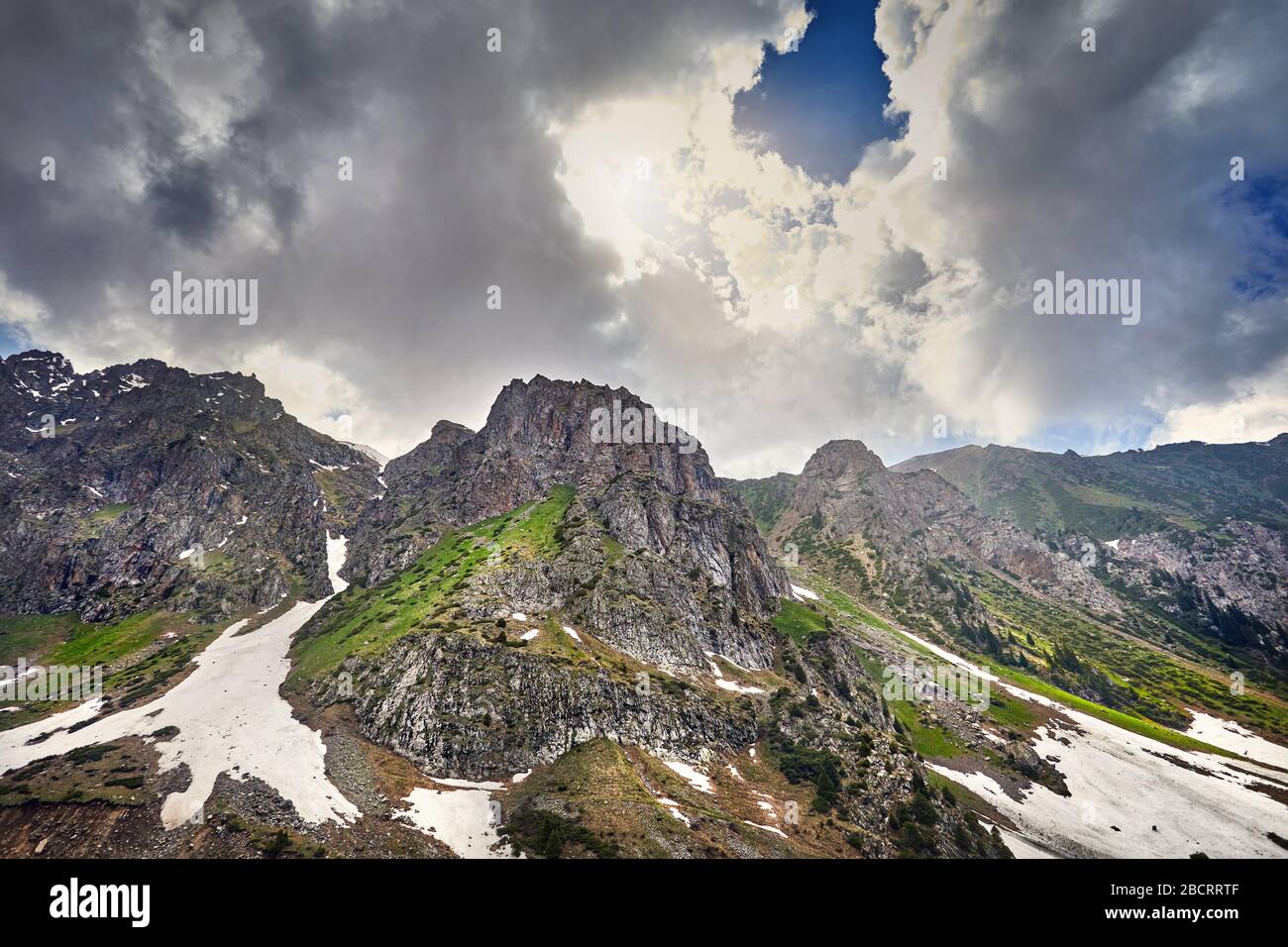 Landscape of Rocky Mountains with overcast sky background Stock Photo ...
