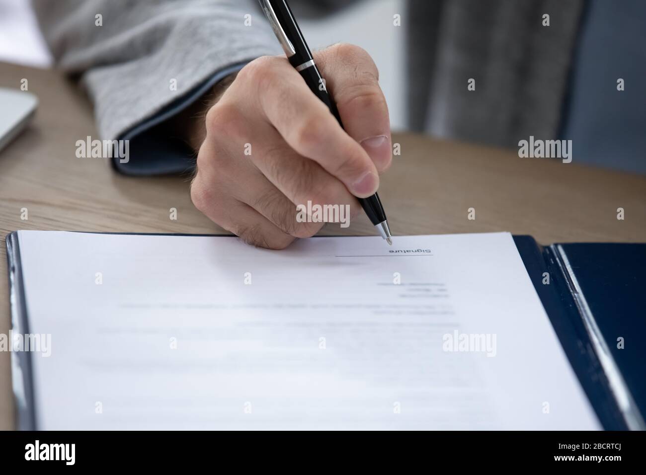 Close up confident businessman signing partnership agreement concept ...
