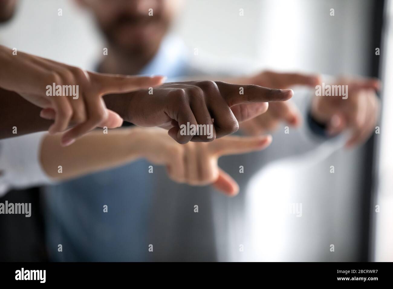Diverse business team hands showing pointing fingers to main goal Stock ...