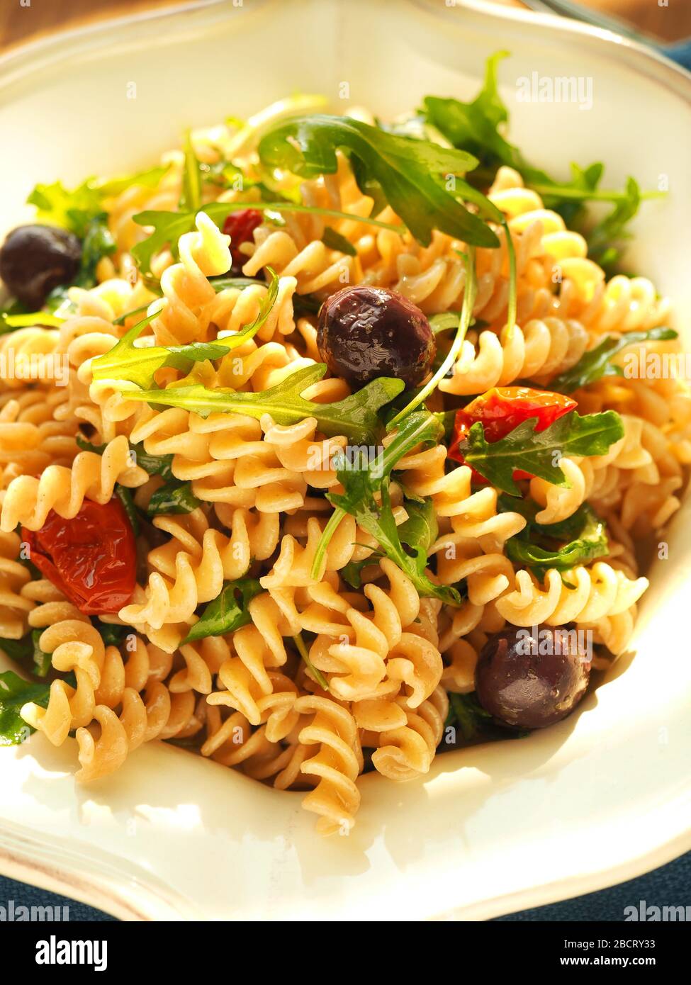 Whole wheat tortiglioni pasta cold with rocket salad, dried Pachino ...