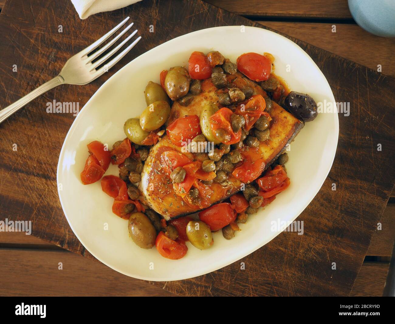 Pesce Spada alla Ghiotta, traditional swordfish calabrian recipe with capers, olives, tomato ...