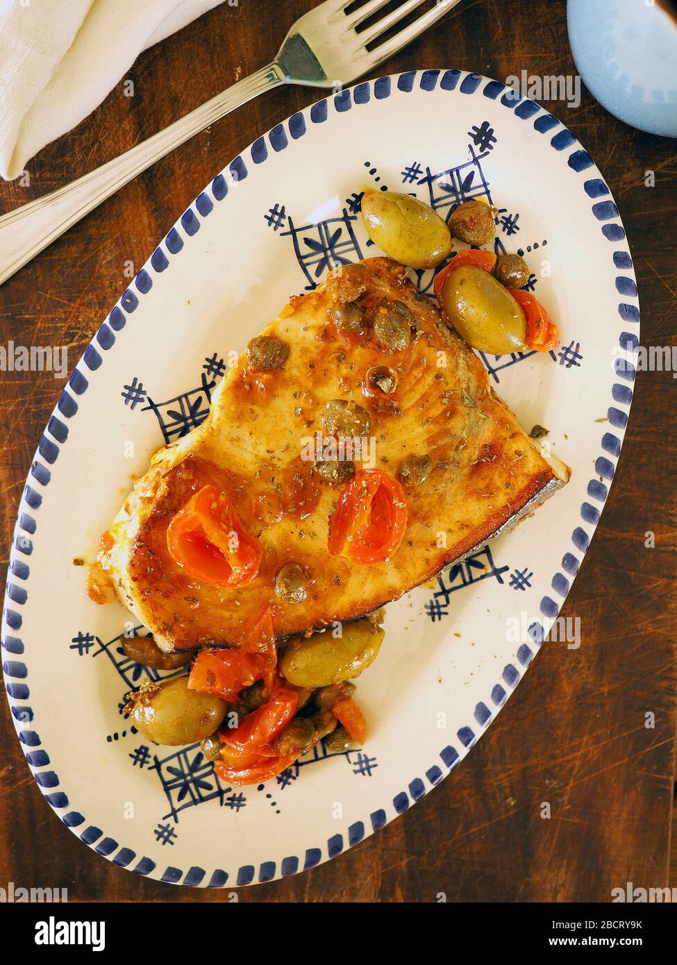 Pesce Spada alla Ghiotta, traditional swordfish calabrian recipe with capers, olives, tomato ...