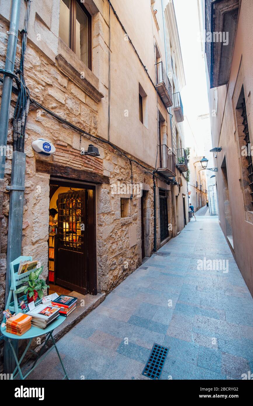 Medieval streets of Girona. Medieval alley with stone walls in Girona ...