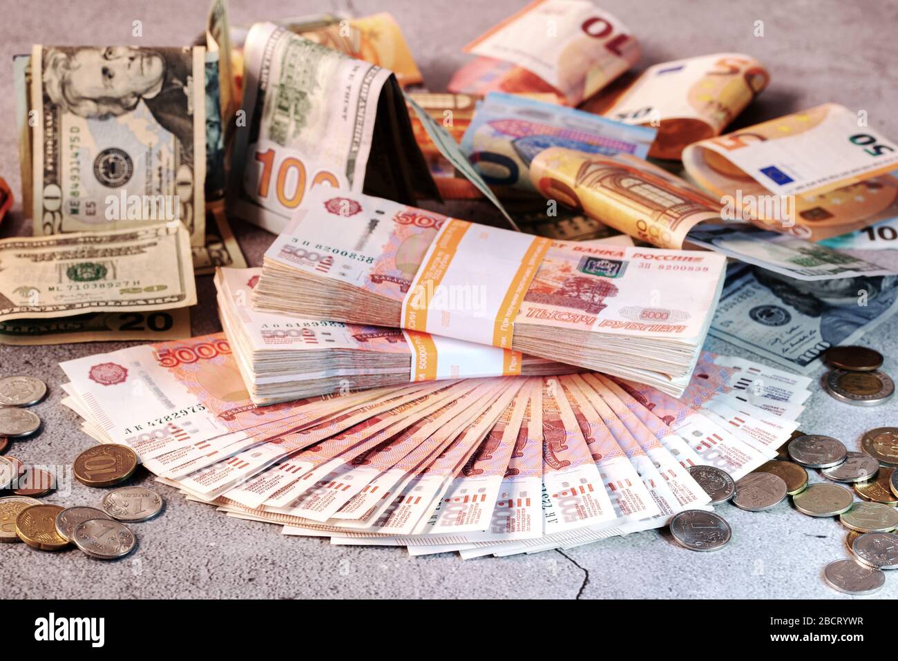 Large stack and fan of banknotes, Russian rubles and different coins ...
