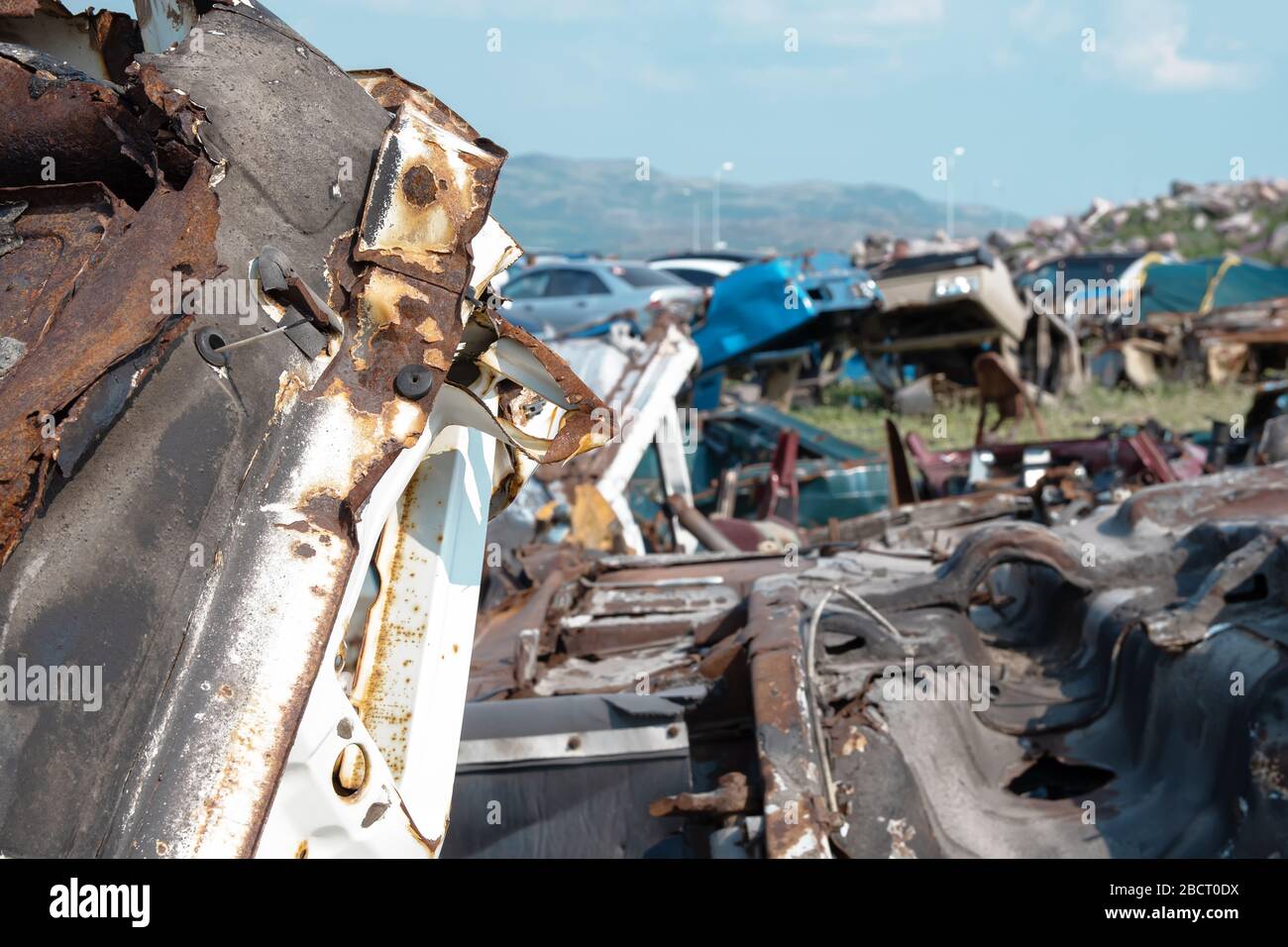 Landfill of old rusty cars on the junkyard, variated color cars blurred ...